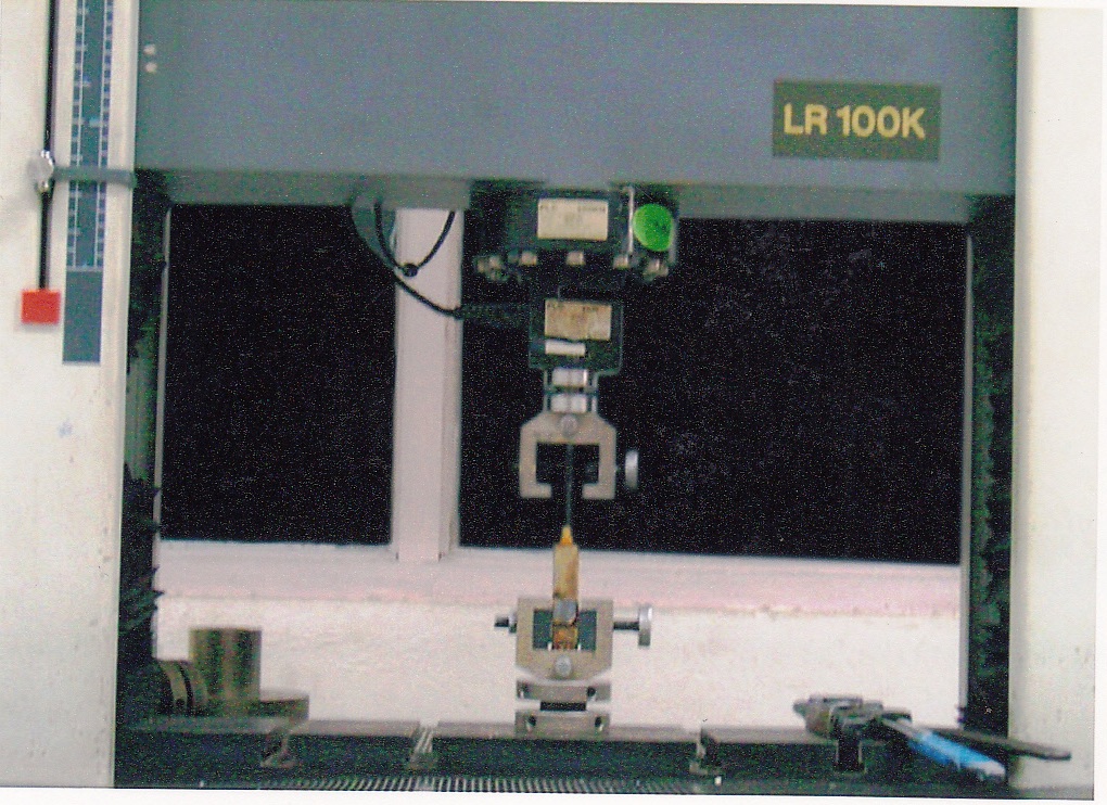 Mounted specimen undergoing testing in Universal Testing Machine (UTM)